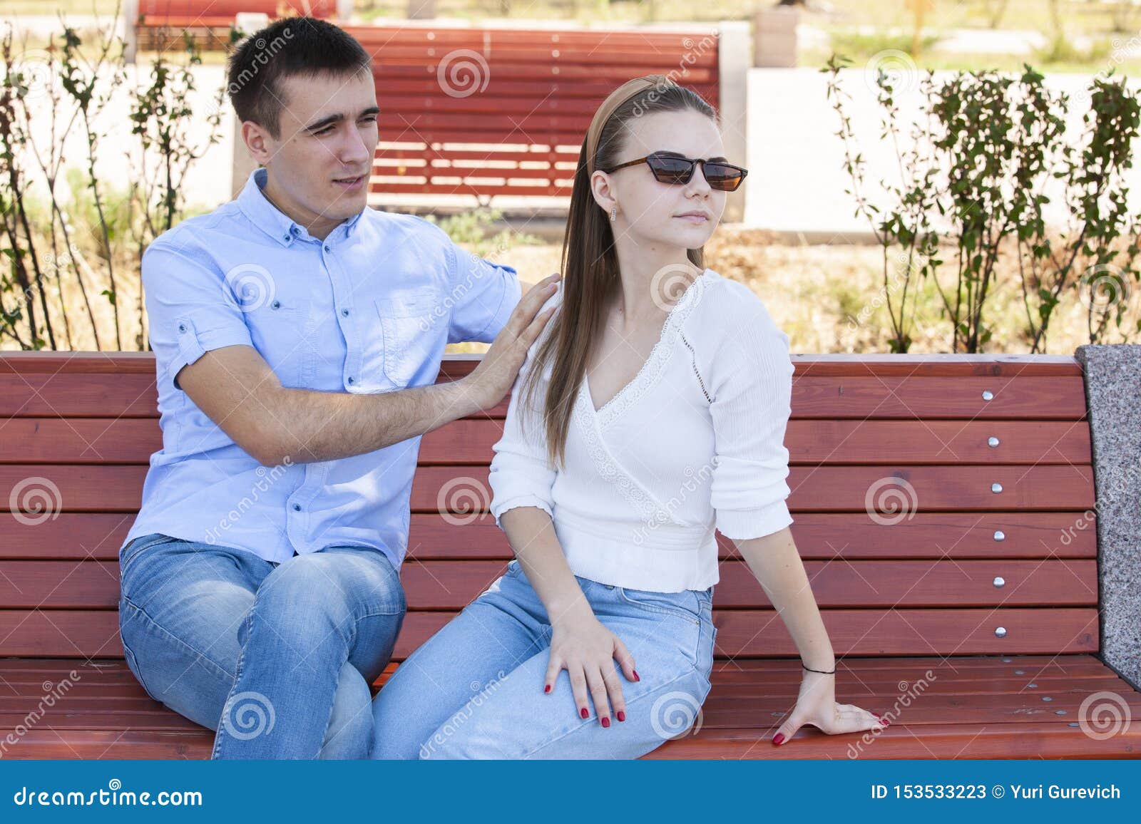 Happy Young Couple In Love Sitting On A Park Bench Stock Image Image