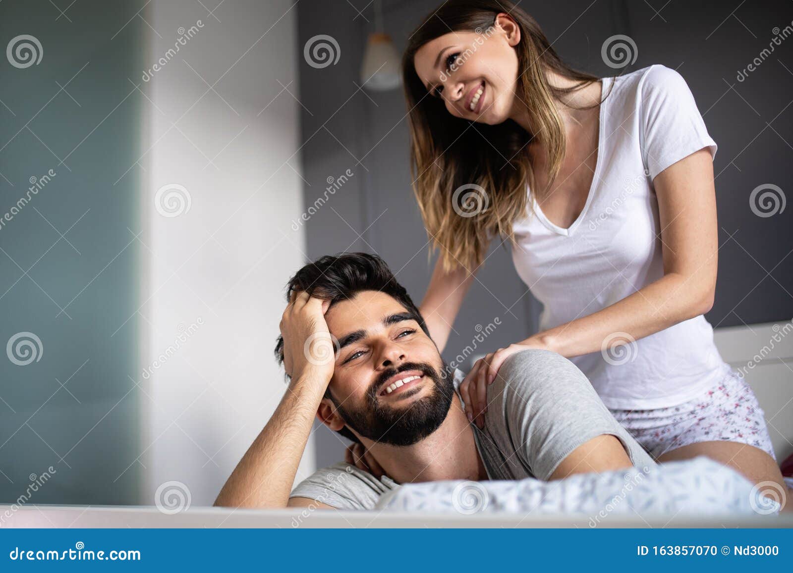 Happy Young Couple Making Massage in Bedroom Stock Photo - Image of ...