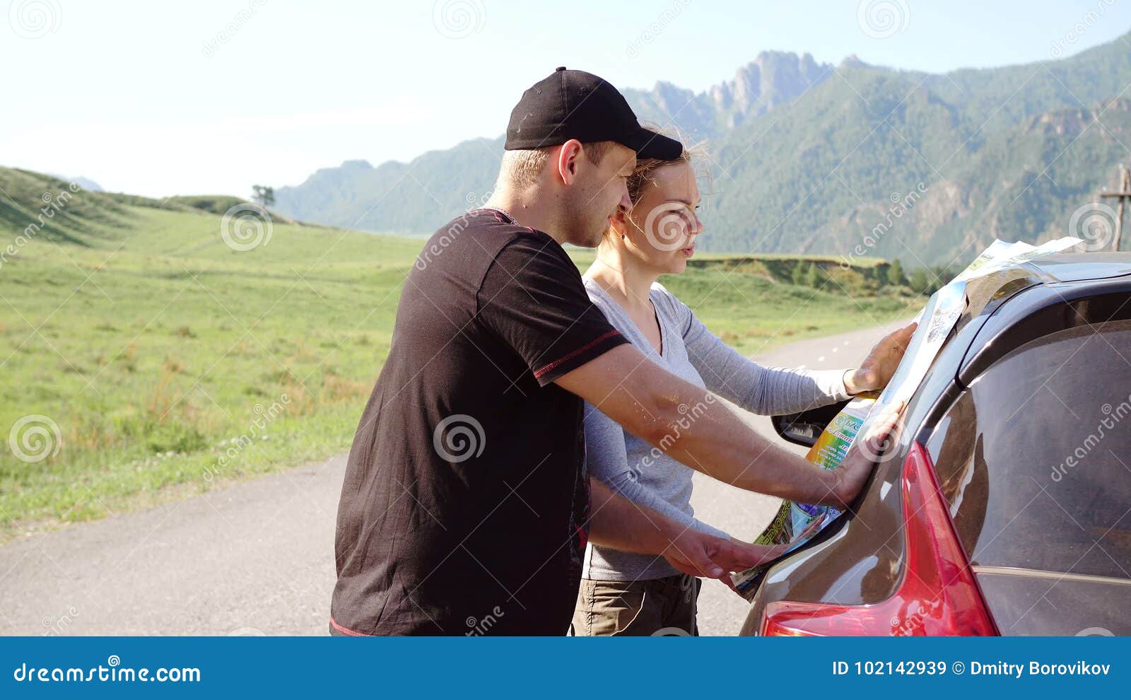 Happy Young Couple with a Map in the Car. they are Using Map on Road ...