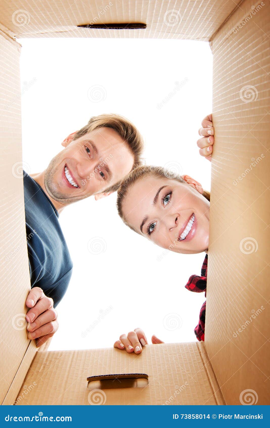 Happy Young Couple Opening a Carton Box and Looking Inside Stock Photo ...