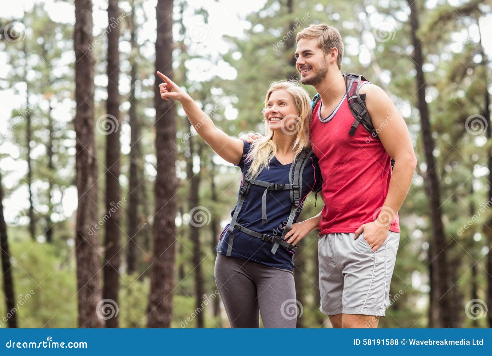 Happy Young Couple Pointing at Something Stock Photo - Image of ...