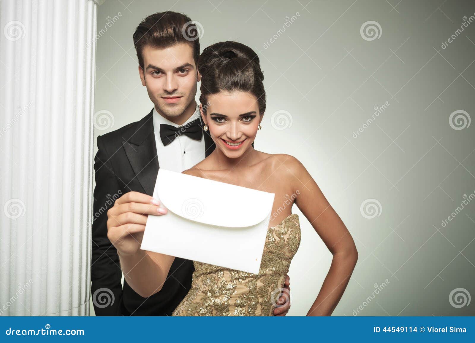 Happy Young Couple Presenting an Invite To Their Wedding Stock Photo ...