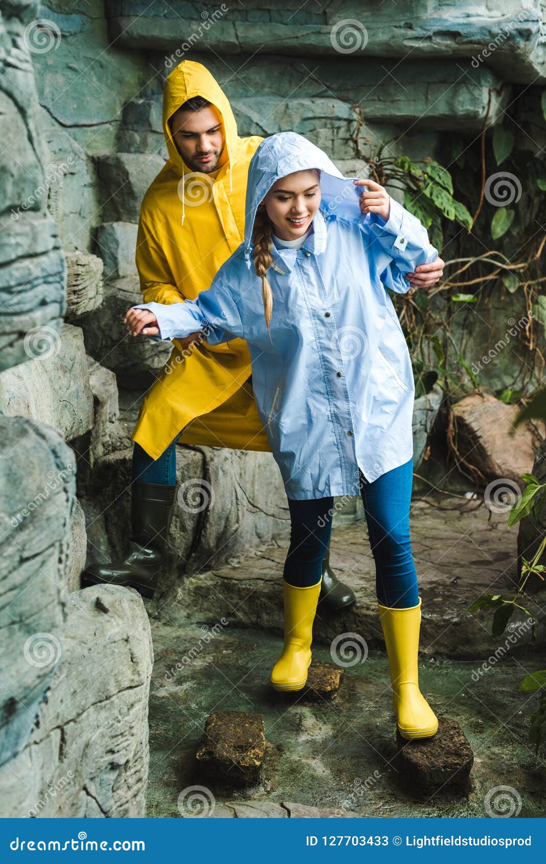 Happy Young Couple in Raincoats Walking Stock Image - Image of male ...