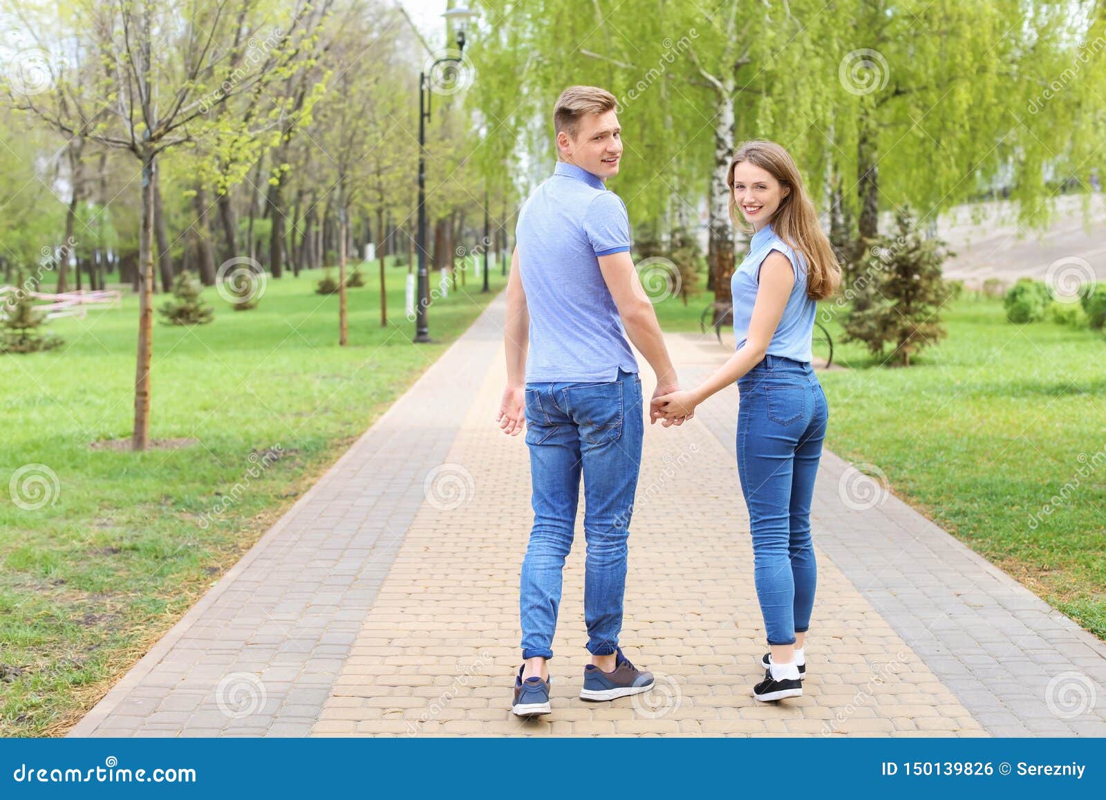 Happy Young Couple Walking in Park on Spring Day Stock Photo - Image of ...