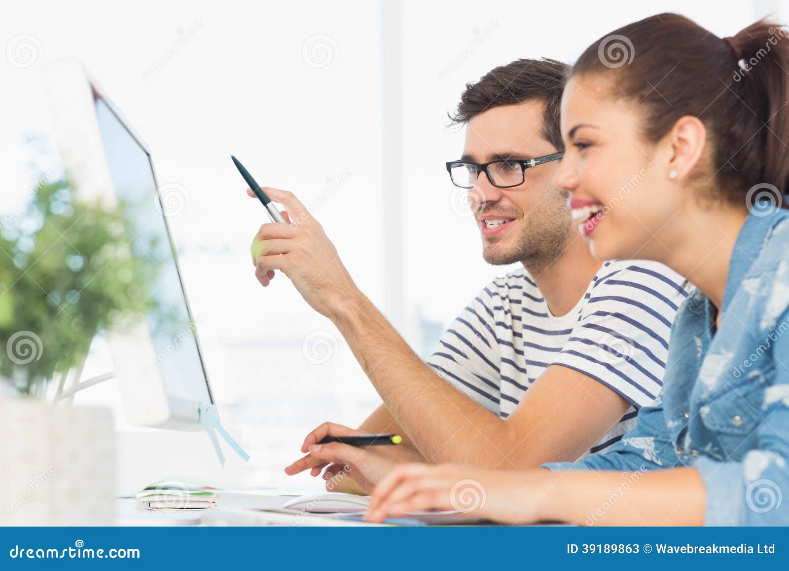 Happy Young Couple Working on Computer in an Office Stock Image - Image ...