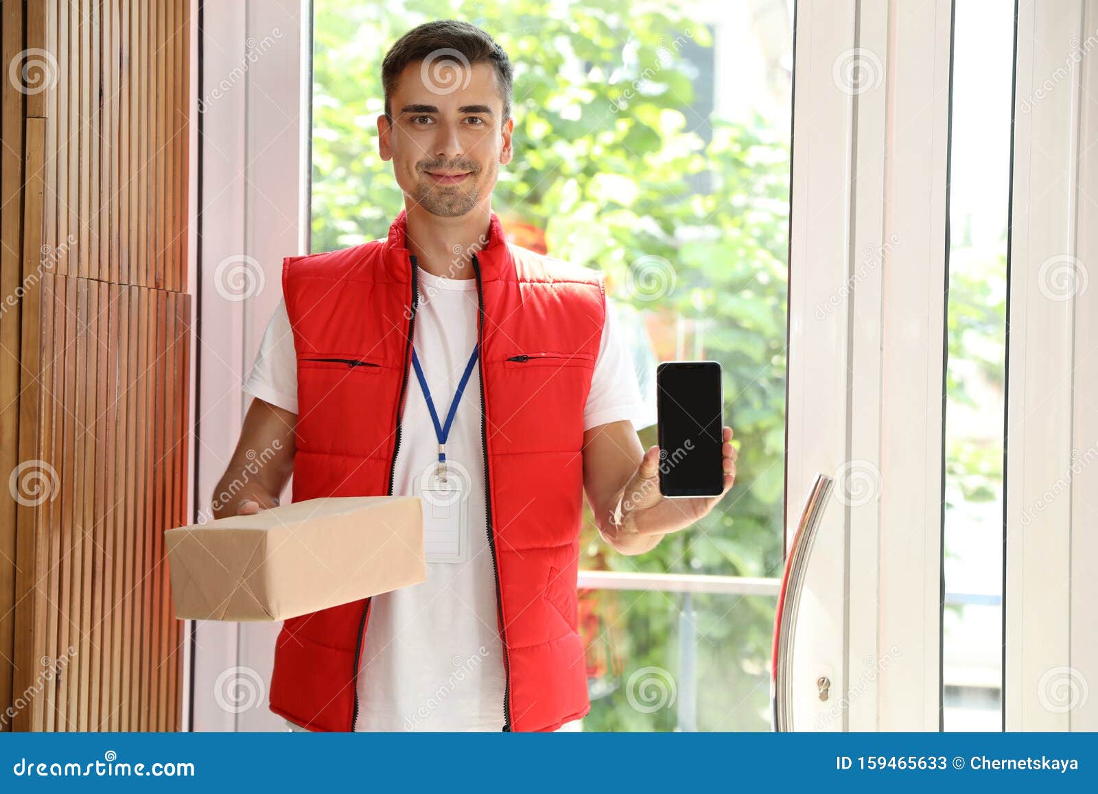 Happy Young Courier with Parcel and Mobile Phone Stock Image - Image of ...