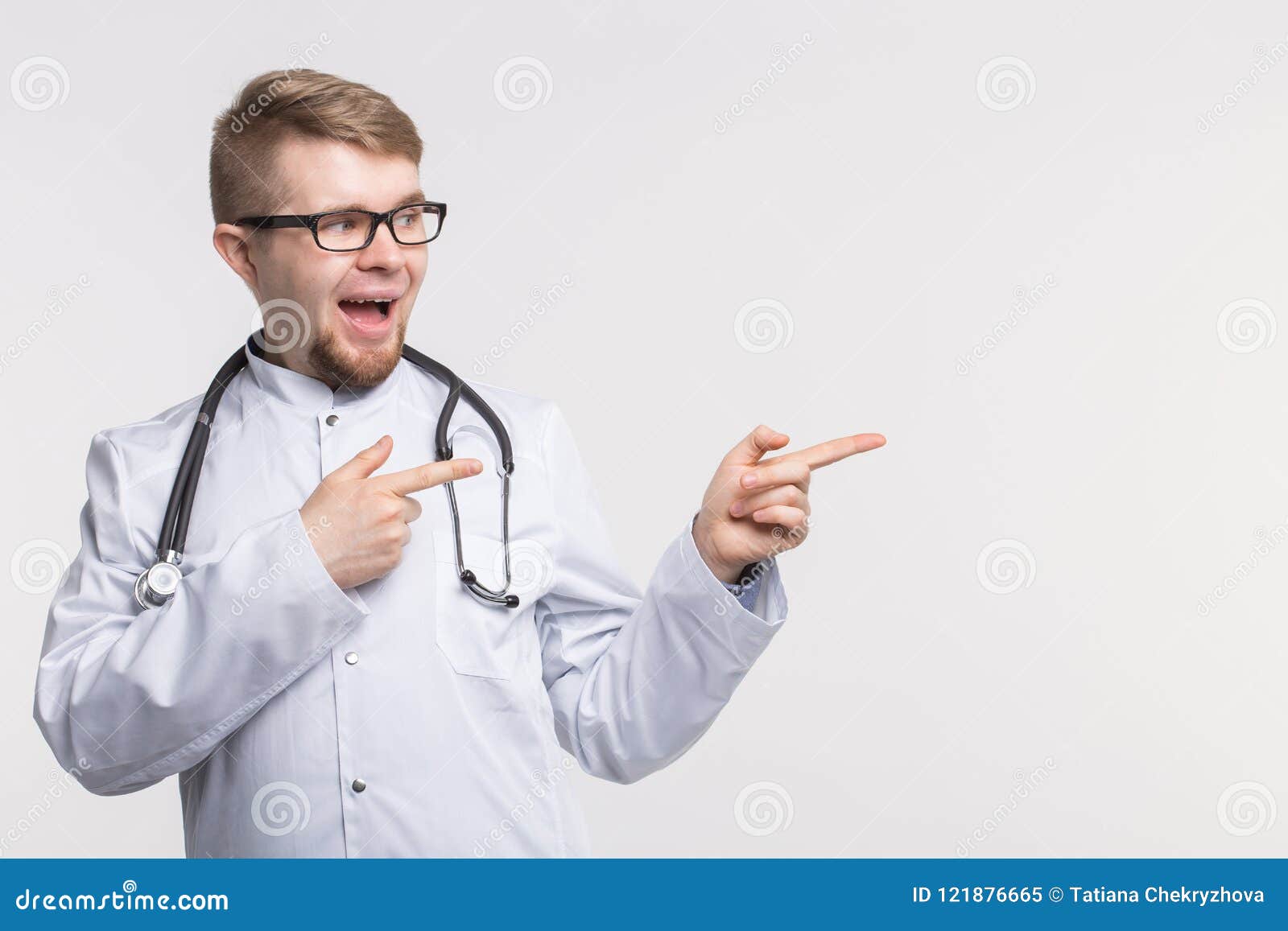 Happy Young Doctor in Studio Pointing Left Stock Image - Image of beard ...