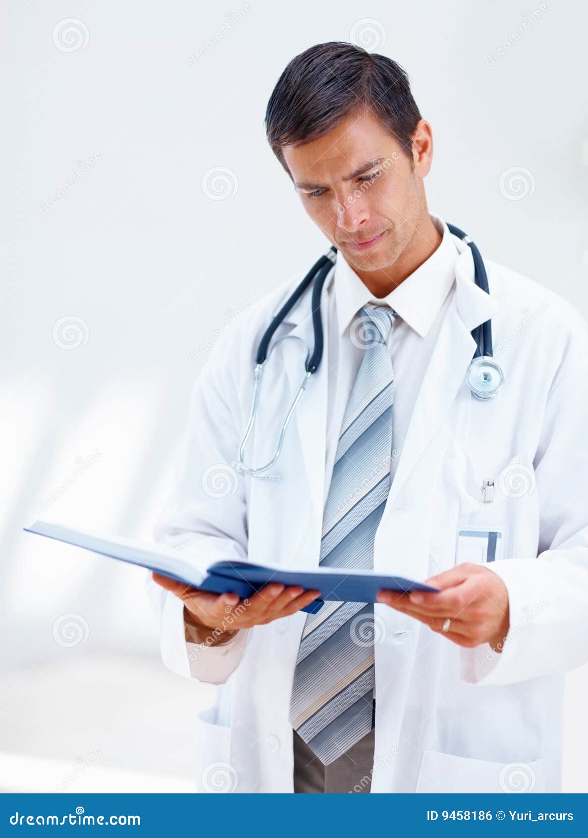 Happy Young Doctor Studying a Patient S File Stock Photo - Image of ...