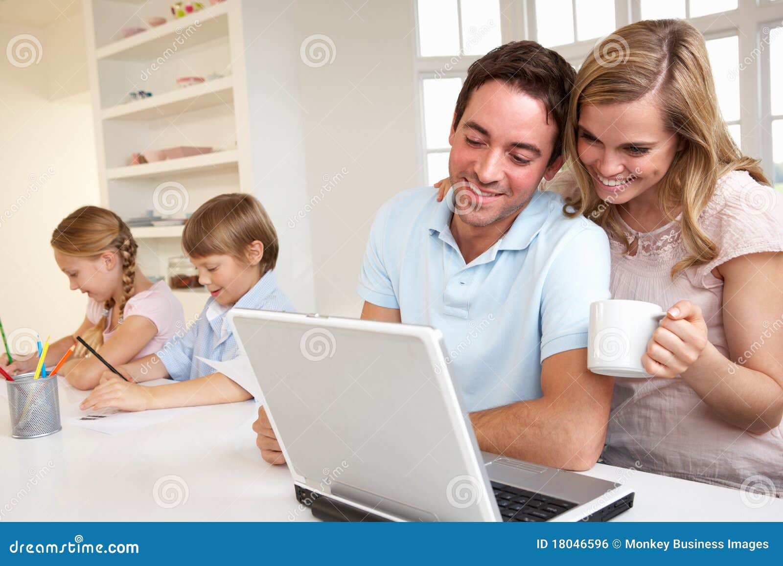 Happy Young Family Looking and Reading a Laptop Stock Photo - Image of ...