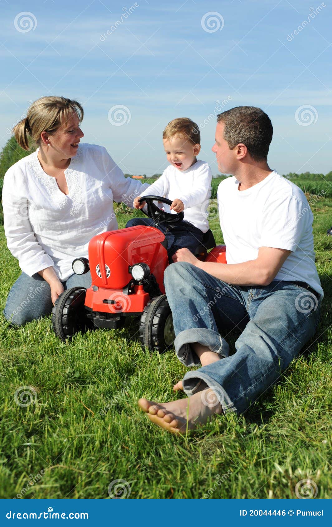 Happy Young Family with Small Child Stock Photo - Image of lawn, luck ...