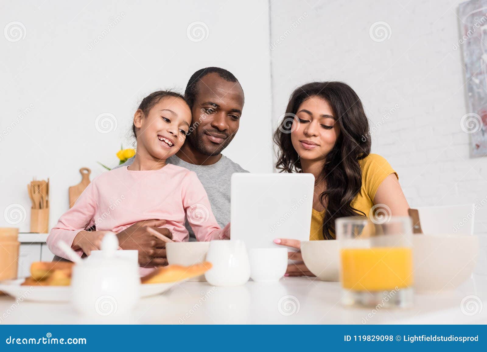 Happy Young Family Using Tablet on Kitchen while Stock Photo - Image of ...