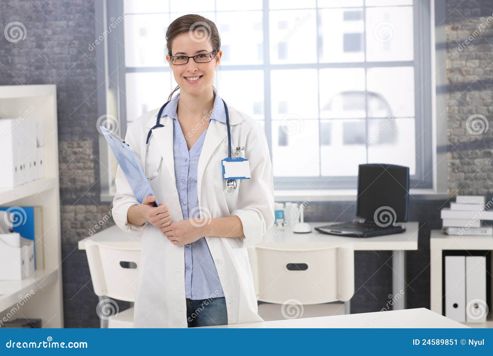 Happy Young Female Doctor In Office Stock Image - Image: 24589851