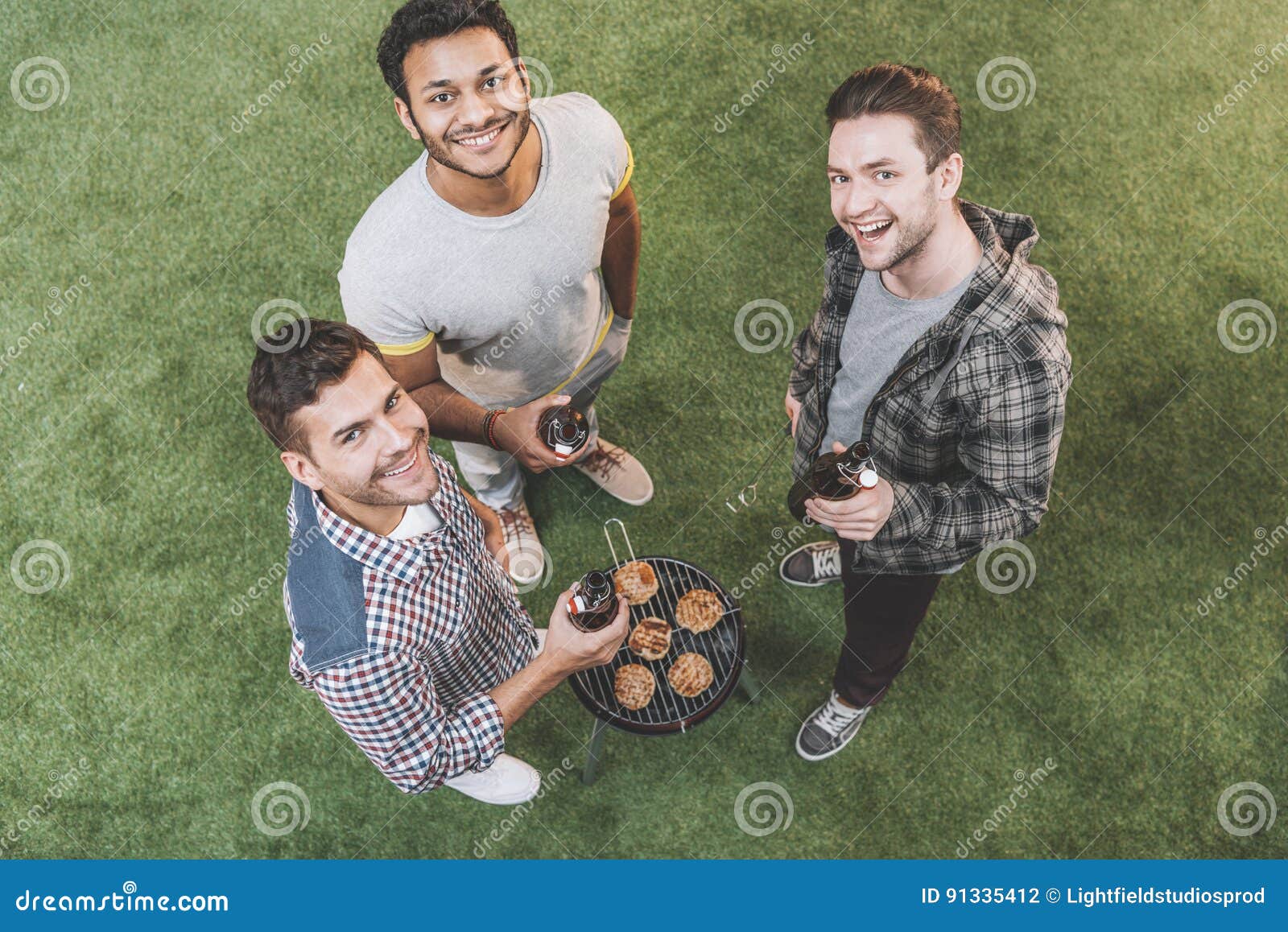 Happy Young Friends Drinking Beer and Making Barbecue Stock Photo ...