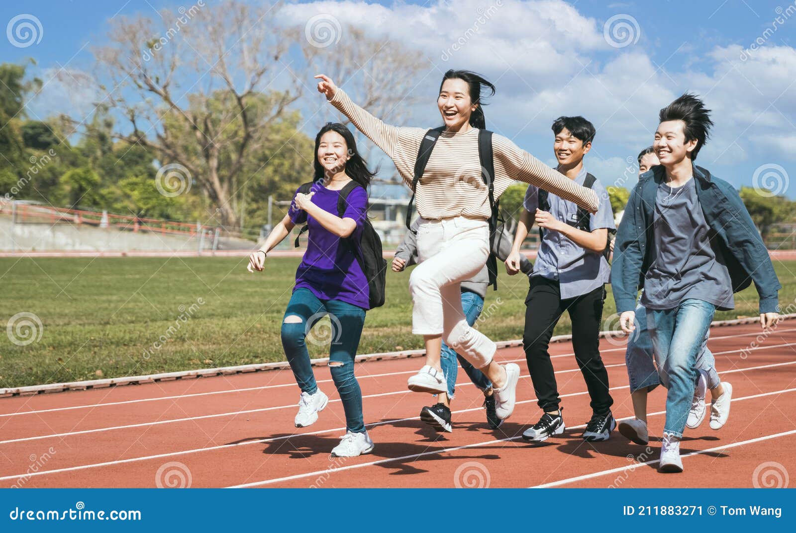 Happy Young Group Students Running Across Field Stock Image - Image of ...