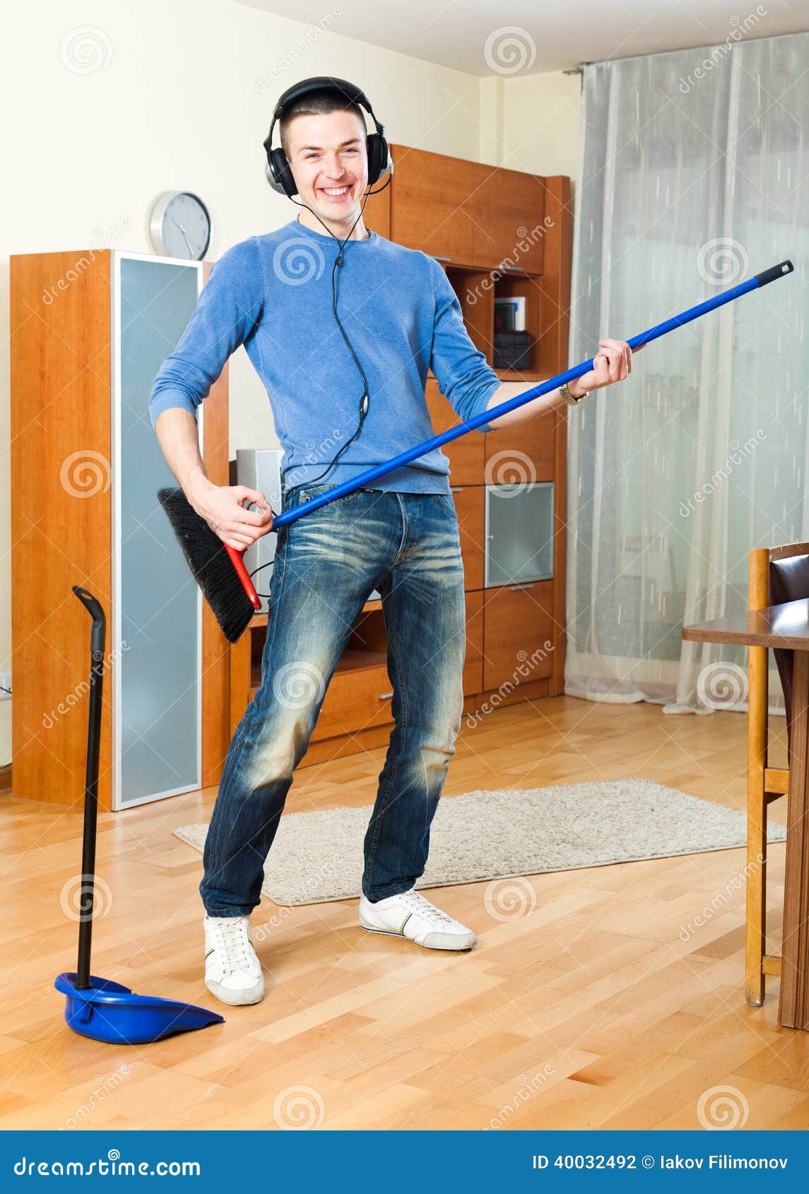 Happy Young Guy with Dustpan and Brush Stock Photo - Image of muffles ...