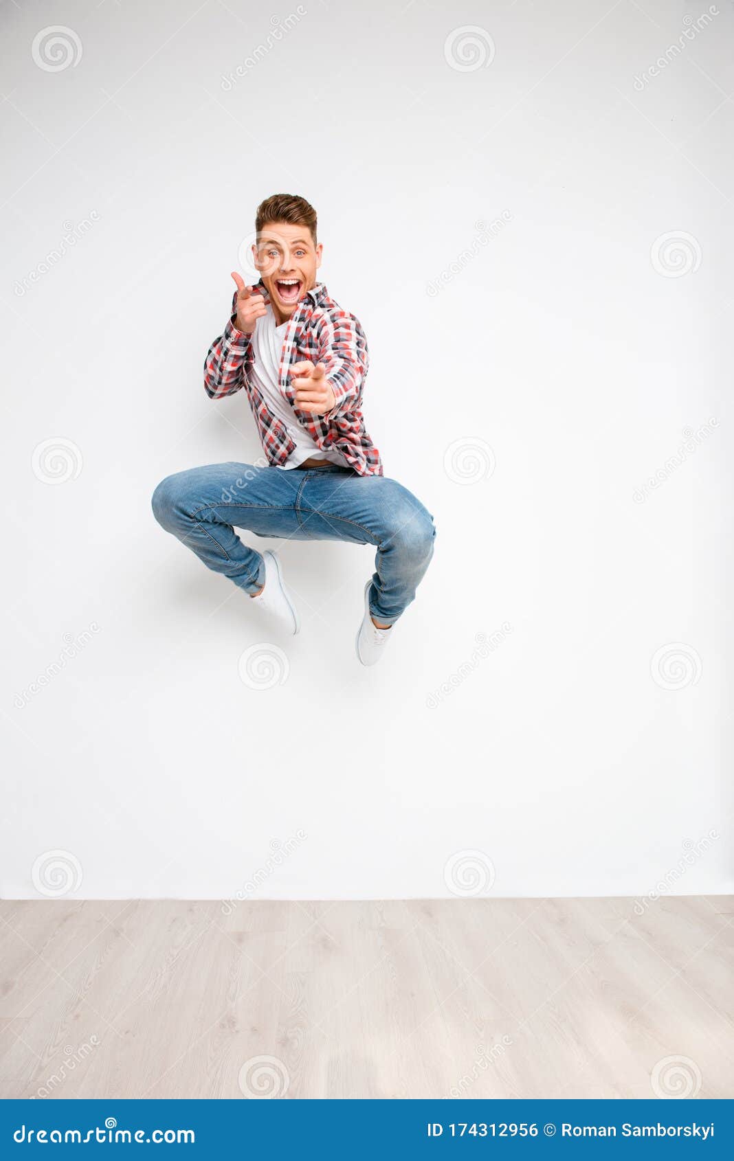 Happy Young Guy Jumping and Pointing on Camera Stock Photo - Image of ...