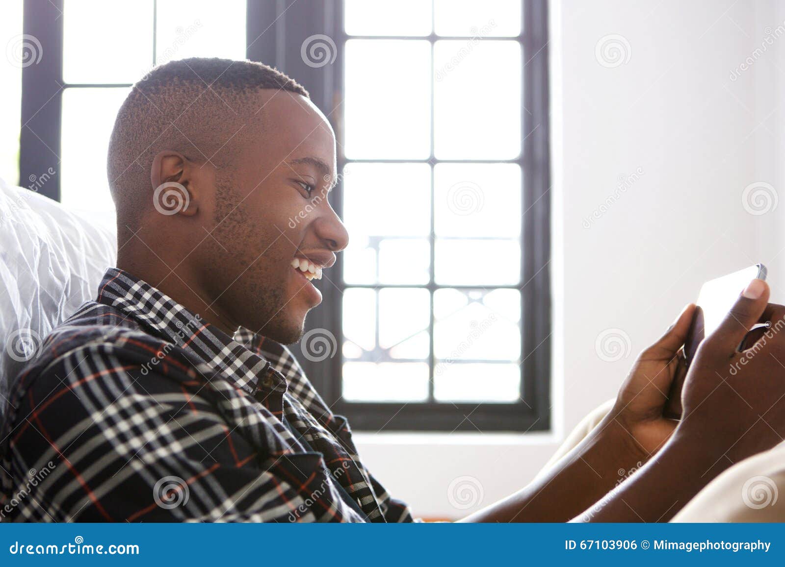 Happy Young Guy Sitting with Digital Tablet and Smiling Stock Photo ...
