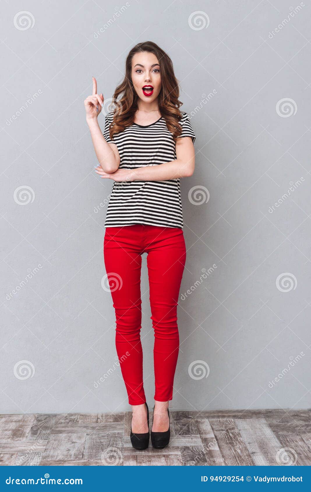 HAppy Young Lady Standing Over Grey Wall Have an Idea Stock Photo ...