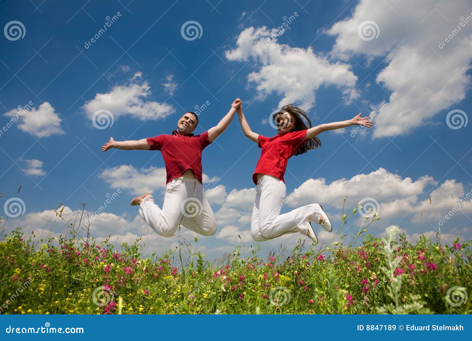 Happy Young Love Couple - Jumping Stock Image - Image of grass, clouds ...
