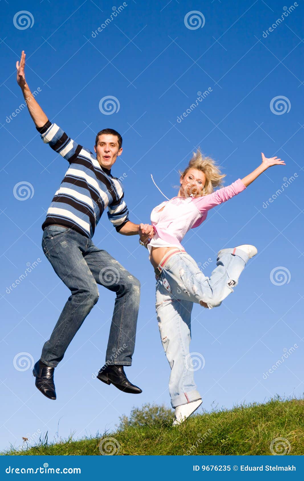 Happy Young Love Couple - Jumping Under Blue Sky Stock Image - Image of ...