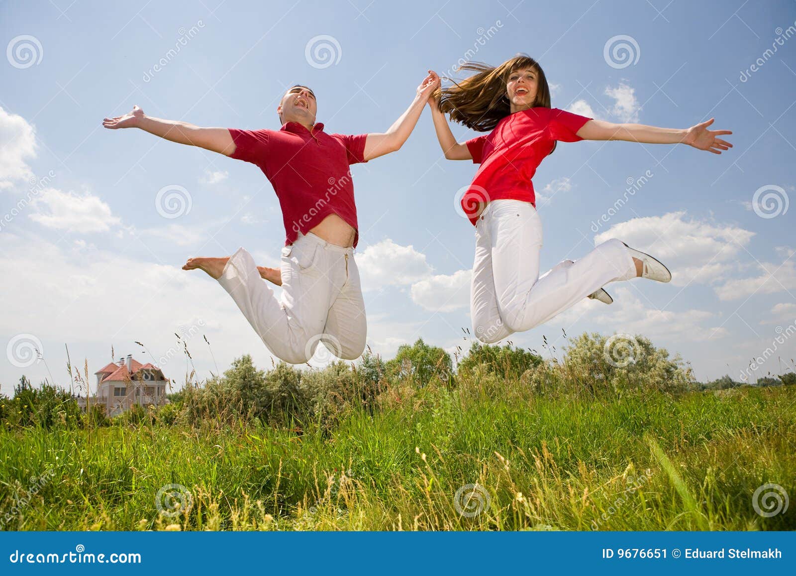 Happy Young Love Couple - Jumping Under Blue Sky Stock Image - Image of ...