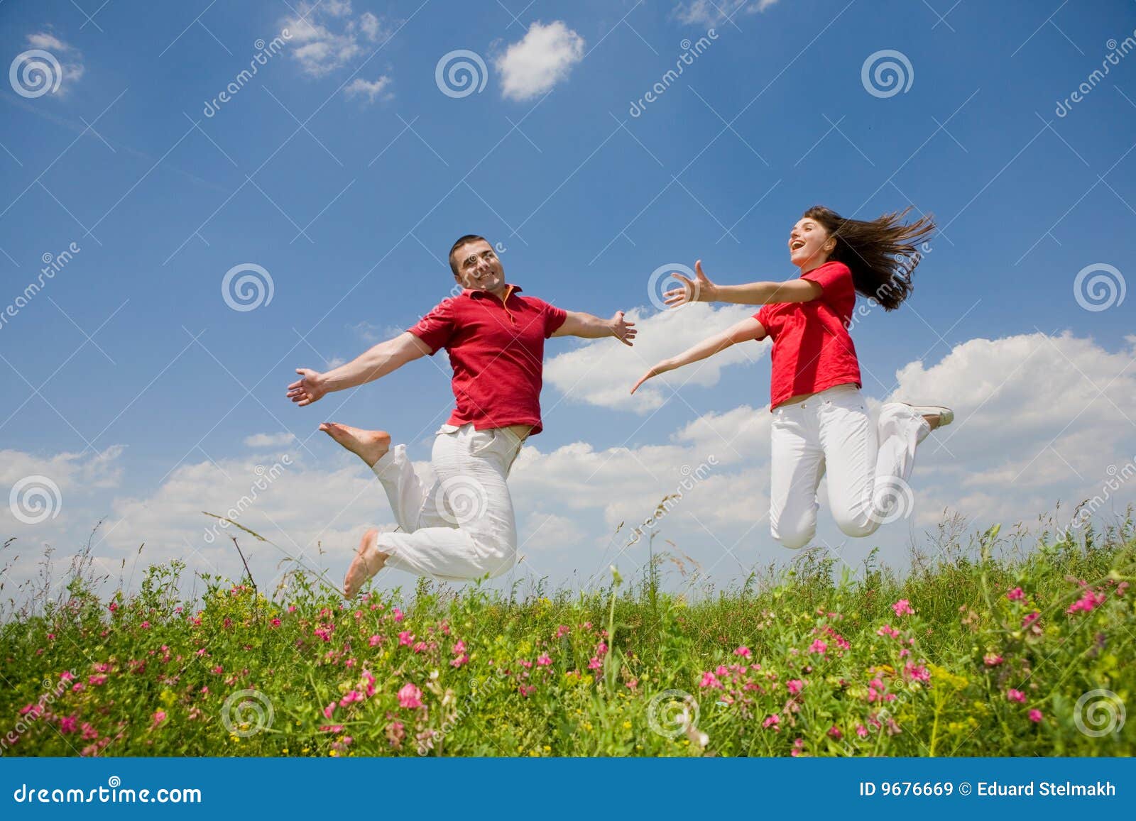 Happy Young Love Couple - Jumping Under Sky Stock Image - Image of ...