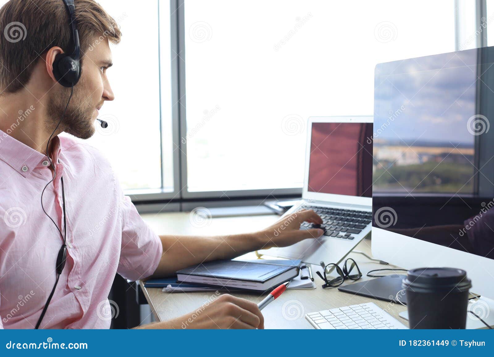 Happy Young Male Customer Support Executive Working in Office Stock ...