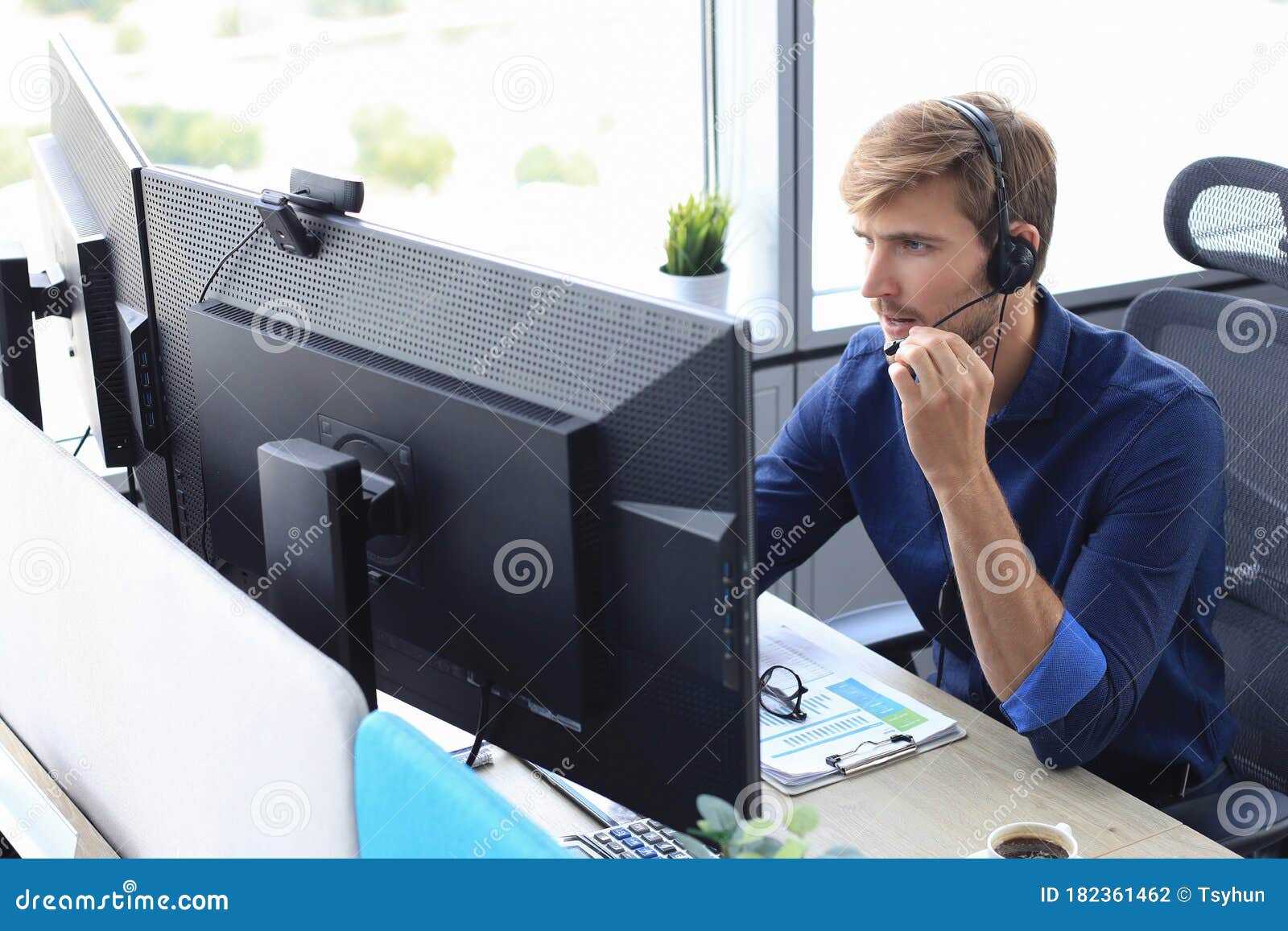 Happy Young Male Customer Support Executive Working in Office Stock ...