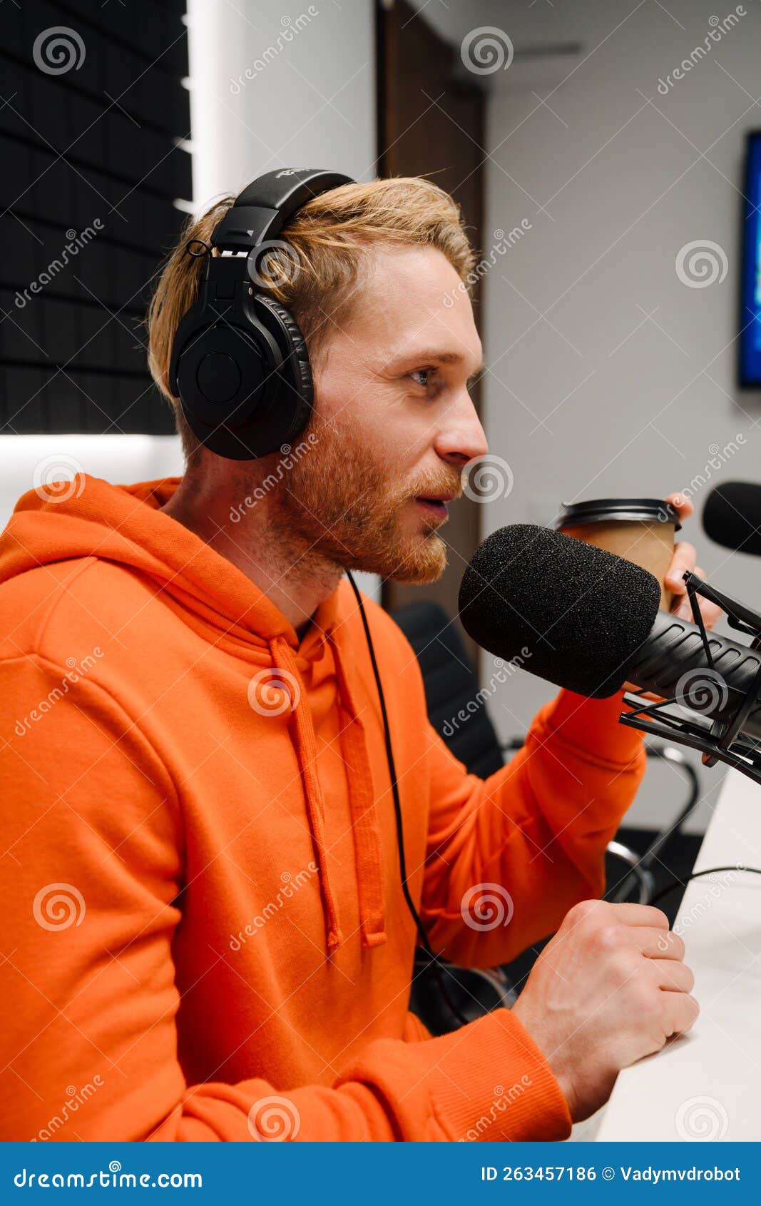 Young Male Radio Host Using Microphone while Broadcasting in Studio ...