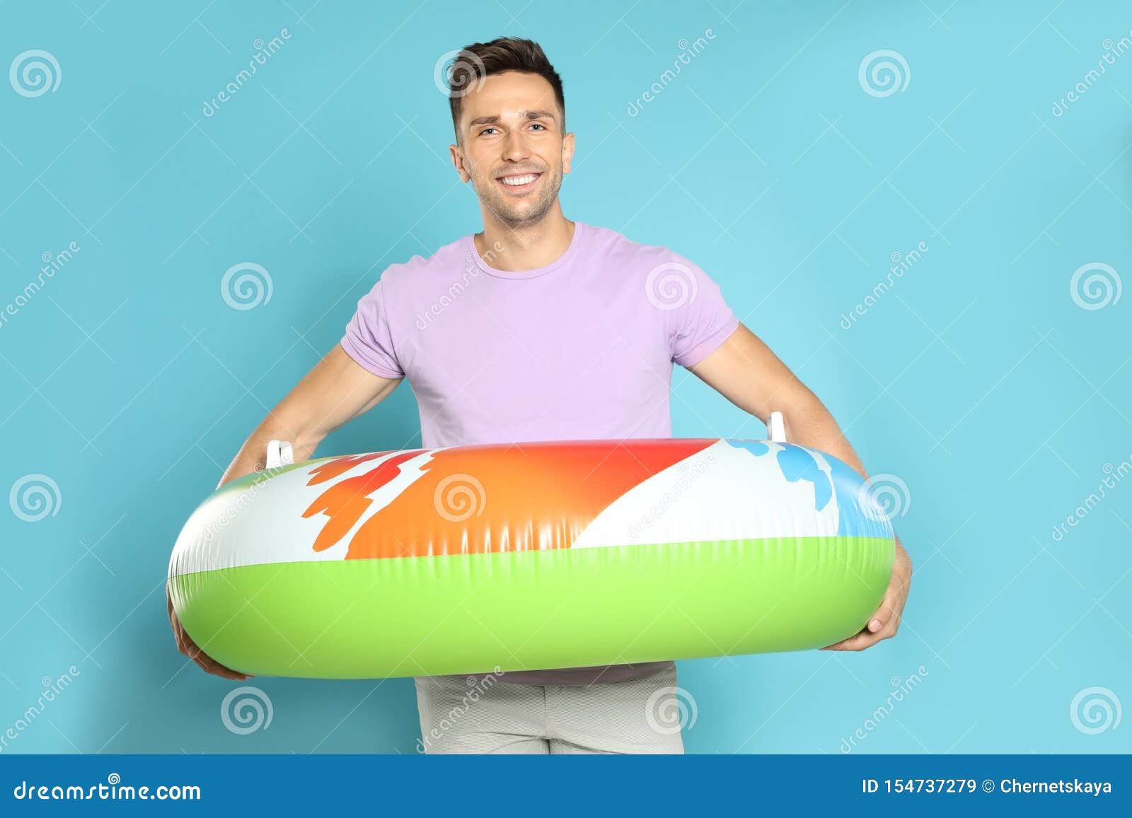 Happy Young Man with Bright Inflatable Ring on Blue Stock Image - Image ...