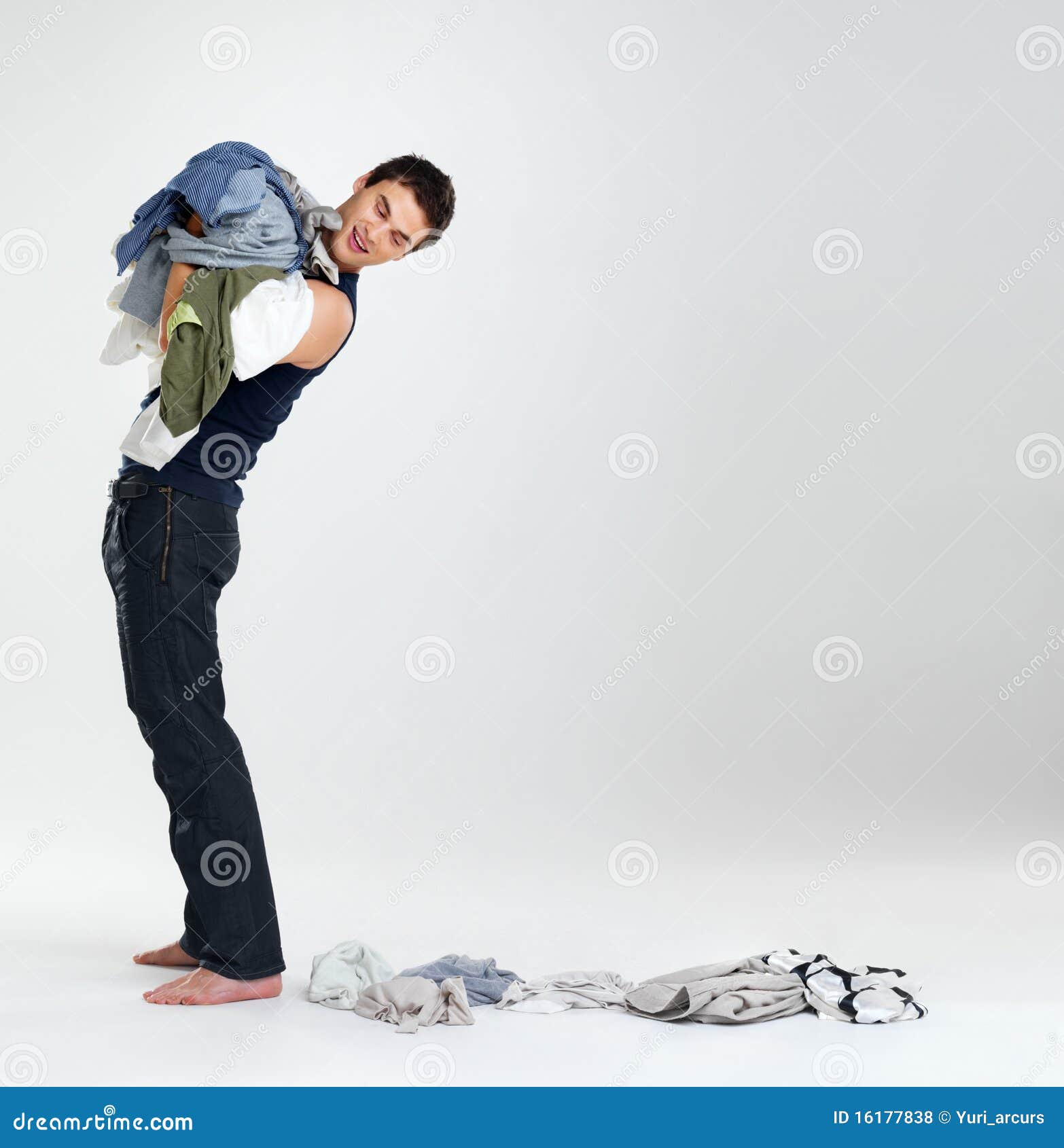 Happy Young Man Carrying Clothes in Laundry Stock Photo - Image of ...