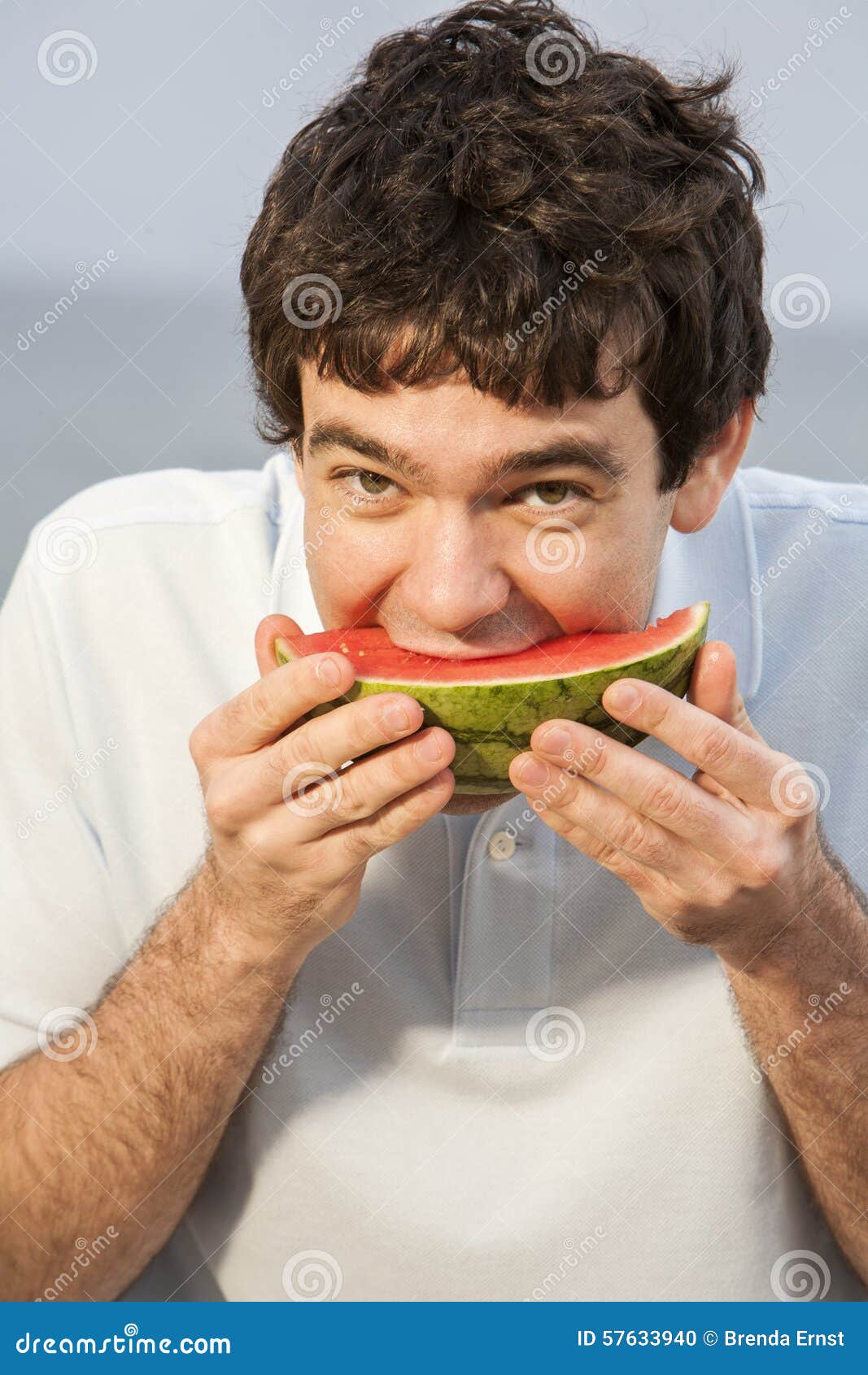 Happy, Young Man Eating Watermelon Stock Photo - Image of blue ...