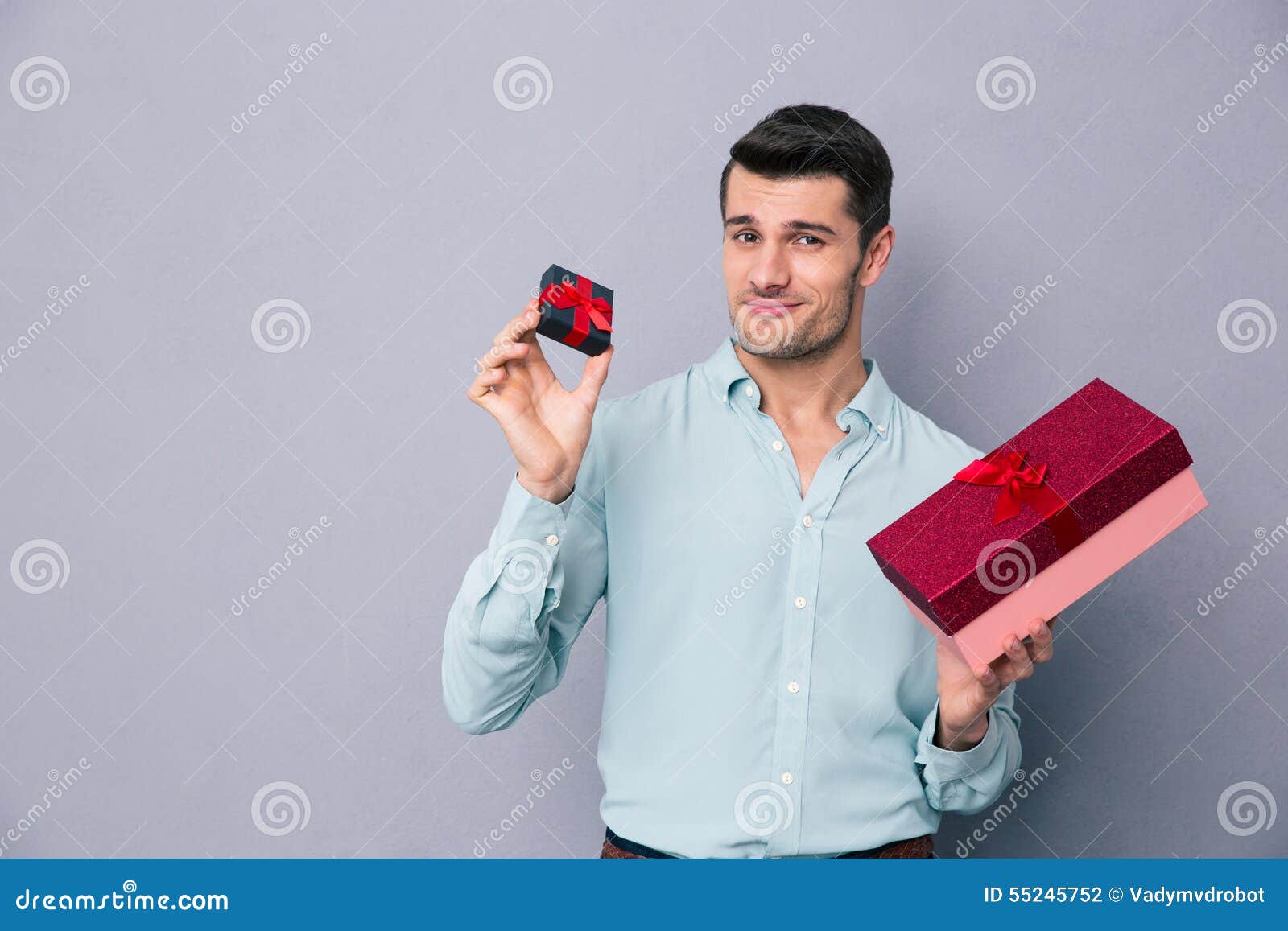 Happy Young Man Holding Small and Big Gift Box Stock Photo - Image of ...