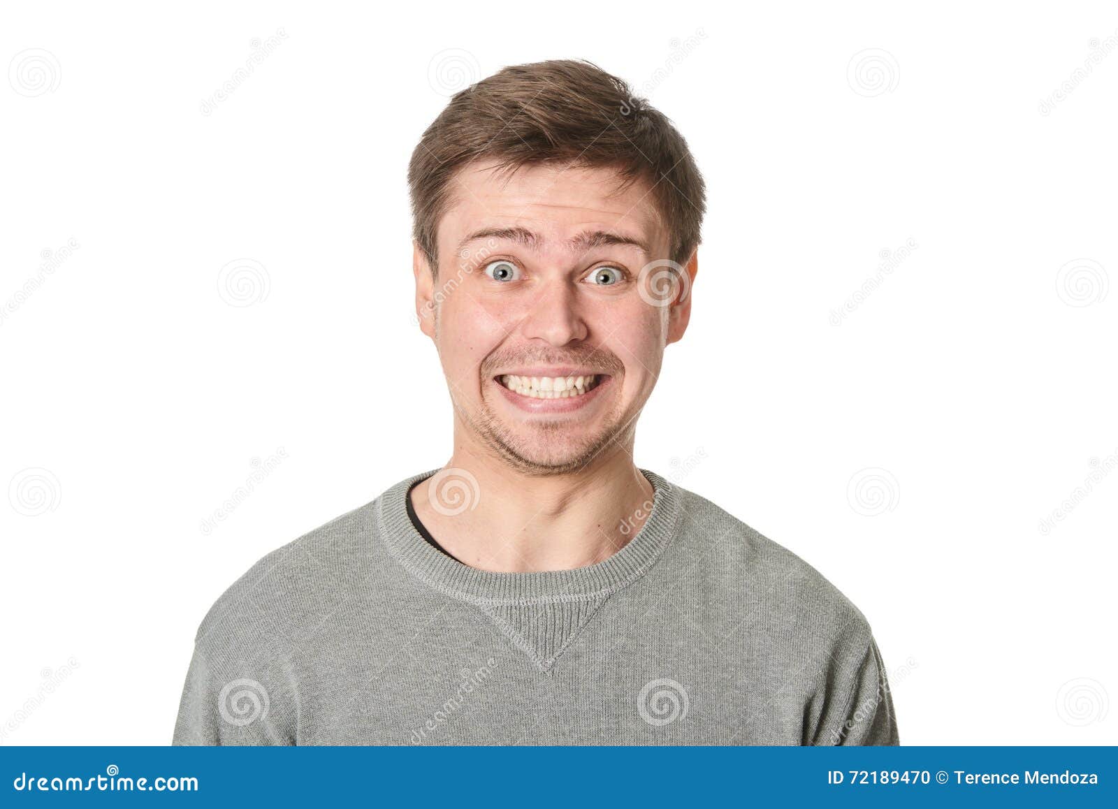 Happy Young Man With Manic Expression, On Gray Background Stock Photo ...