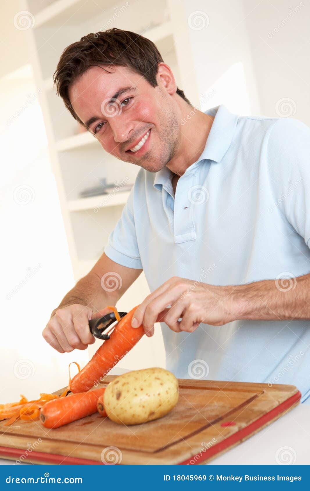 Happy Young Man Peeling Vegetable in Kitchen Stock Image - Image of ...