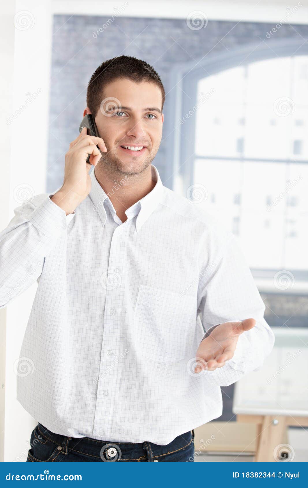 Happy young man on phone stock photo. Image of businessman - 18382344