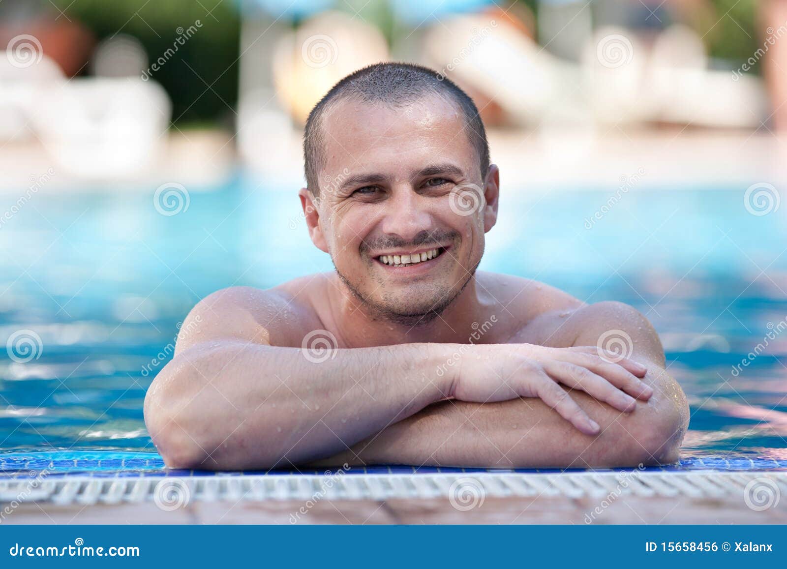 Happy young man in pool stock photo. Image of attractive - 15658456