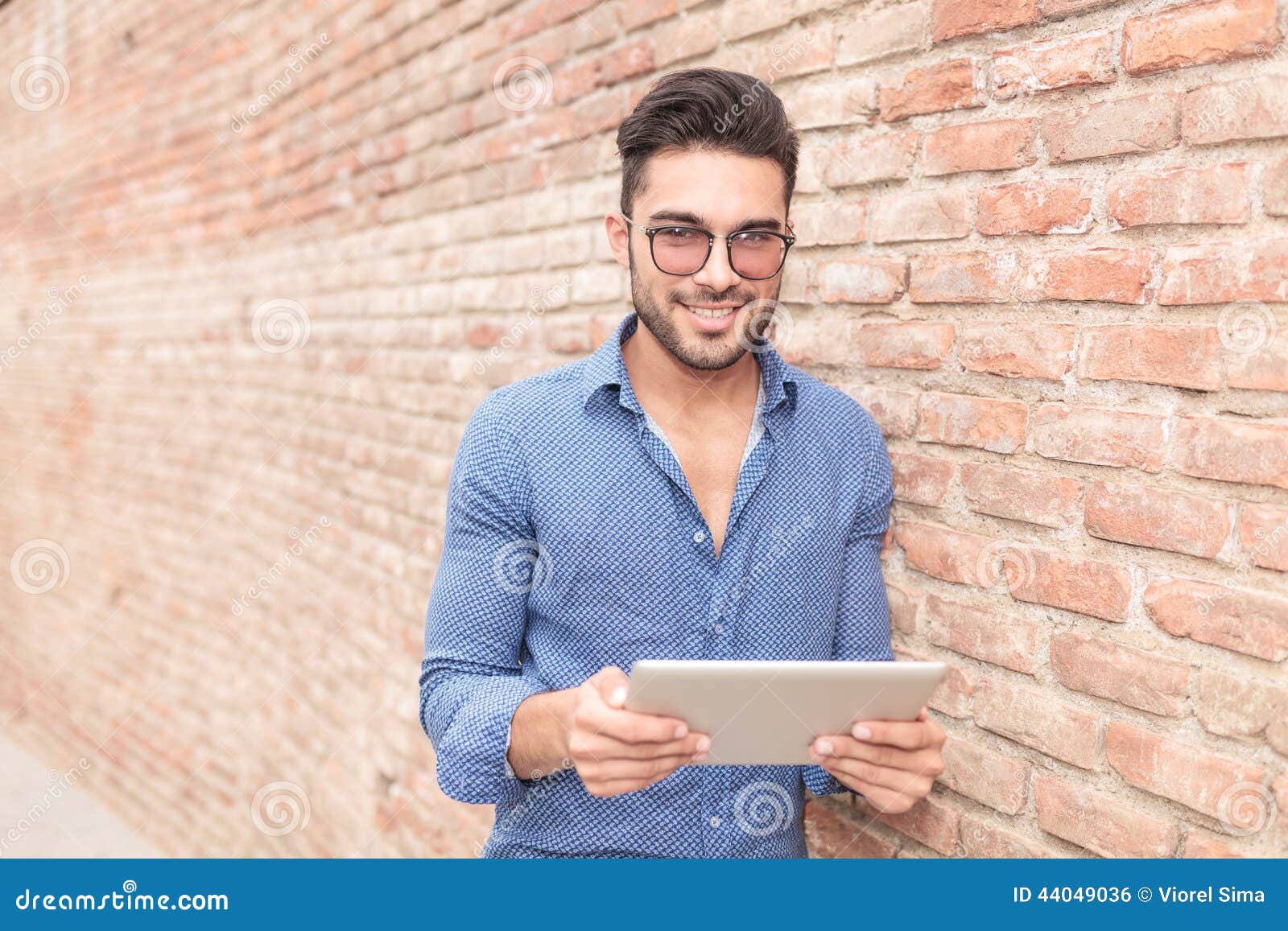 Happy Young Man Reading on a Tablet Computer Stock Photo - Image of ...