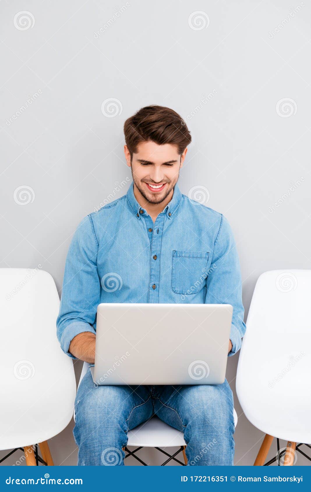 Happy Young Man Sitting on Chair and Working with Laptop Stock Image ...