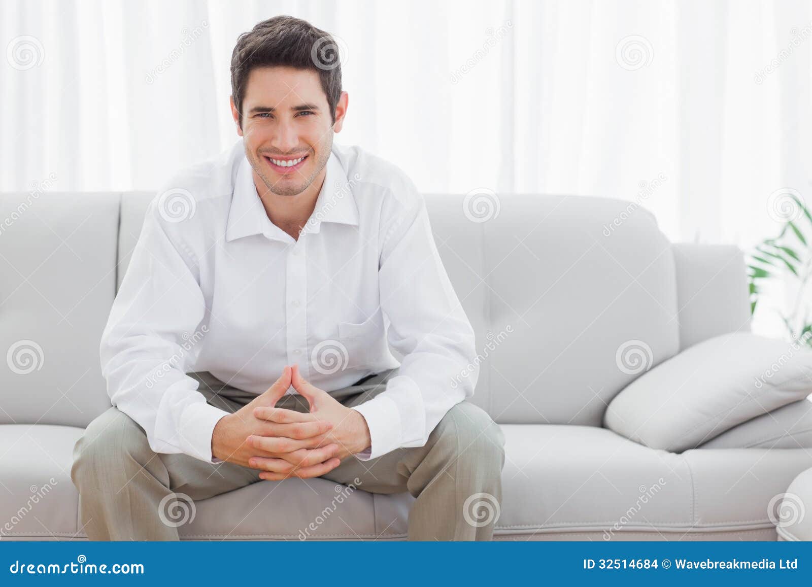Happy Young Man Sitting on Sofa Stock Photo - Image of portrait, short ...