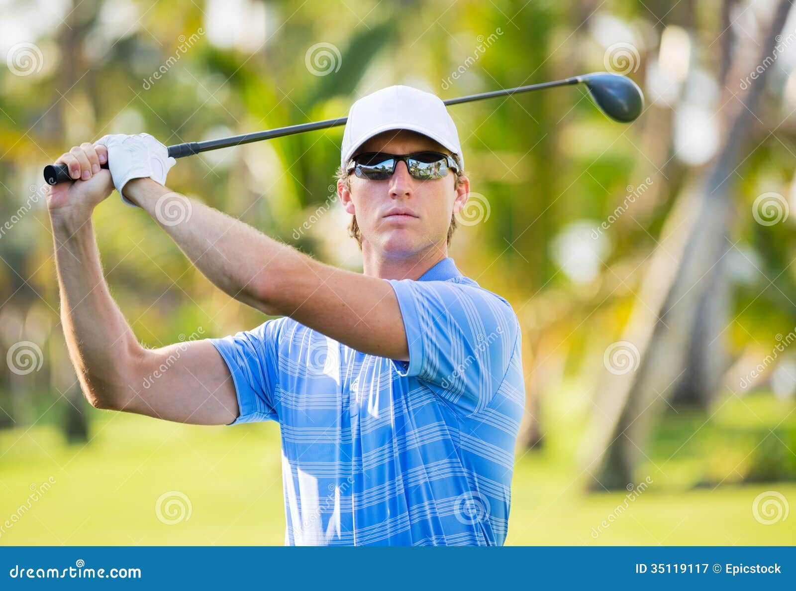 Happy Young Man Swinging Golf Club Stock Image - Image of club, happy ...