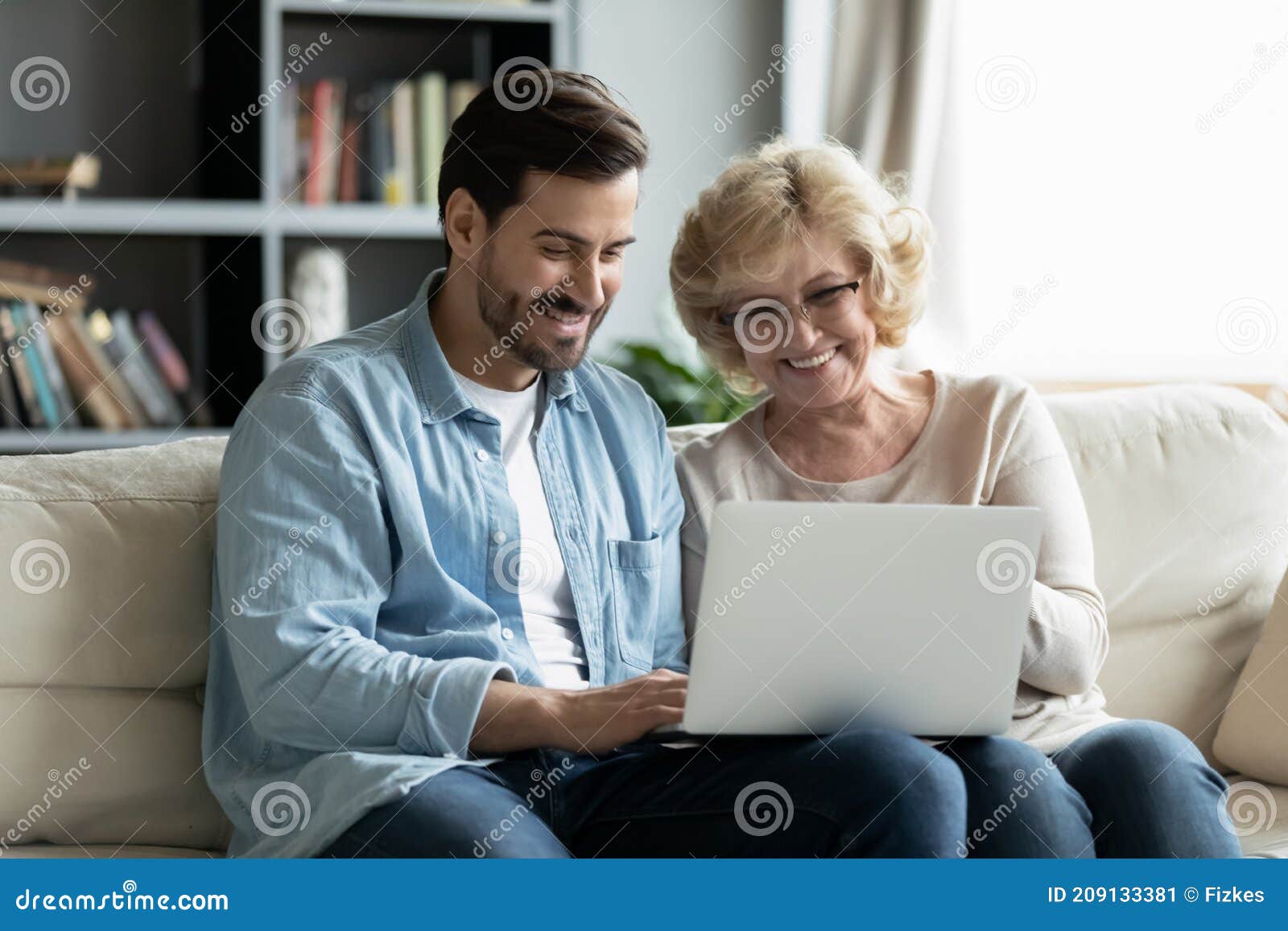 Happy Young Man Teaching Smiling Older Mother Using Computer Apps ...