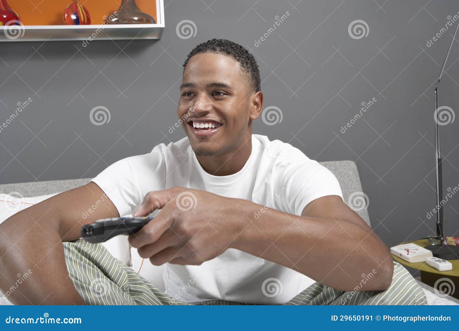 Happy Young Man Watching TV Stock Image - Image of adult, technology ...