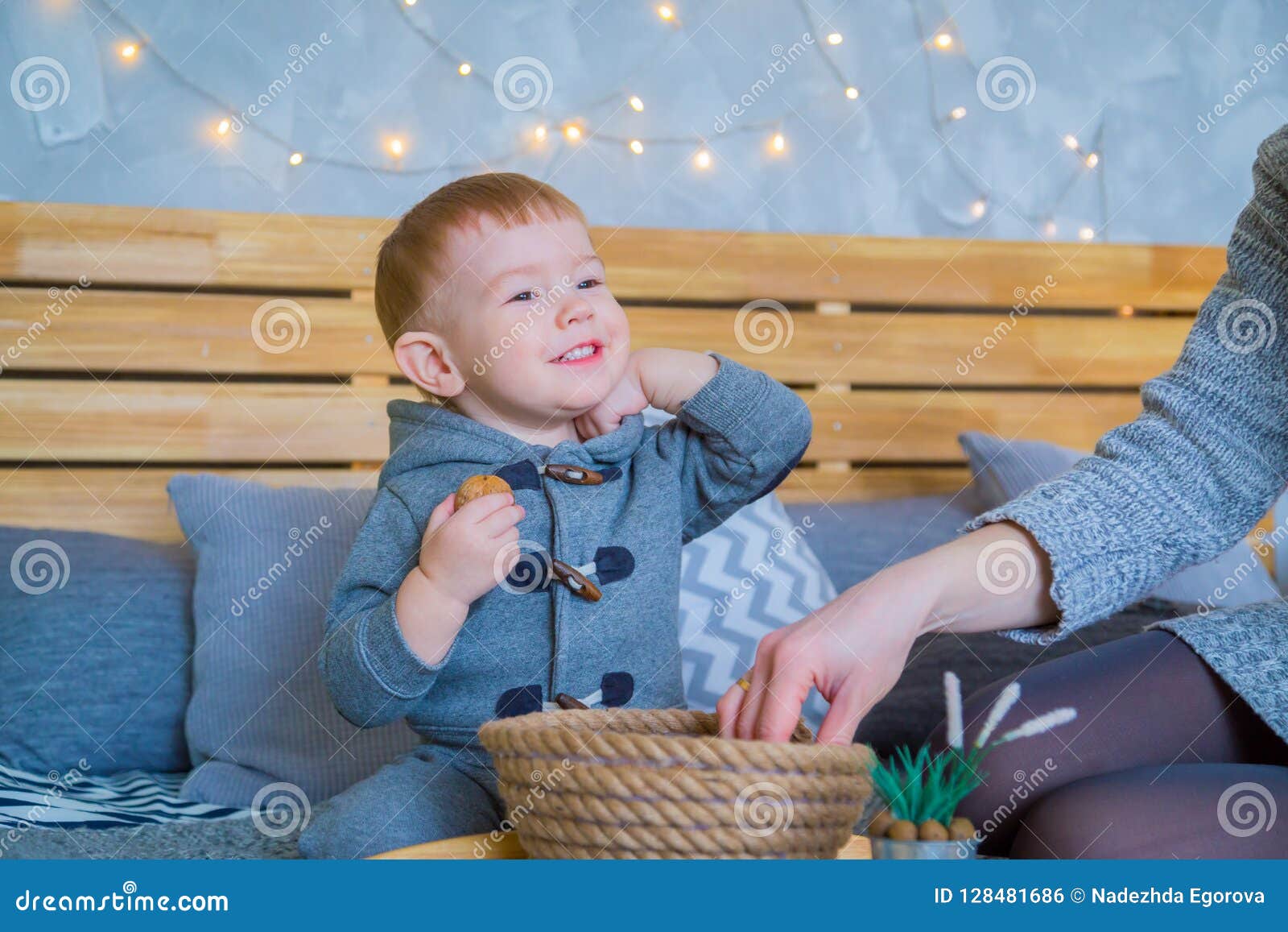 Happy Young Mother and Her Baby Son Playing with Walnuts Stock Photo ...