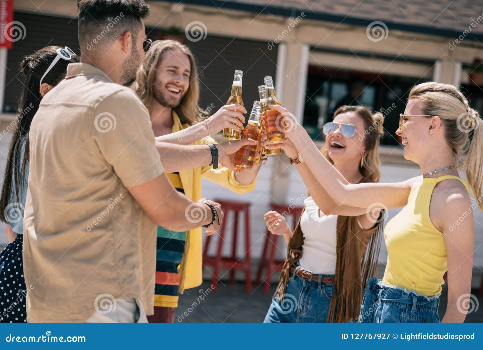 Happy Young People Clinking Beer Bottles Stock Image - Image of youth ...