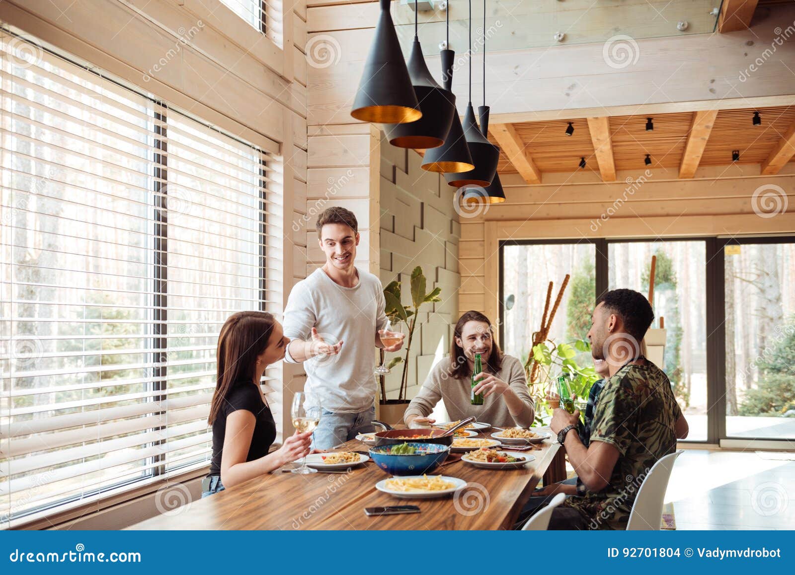 Happy Young People Eating and Giving Toasts on the Kitchen Stock Photo ...