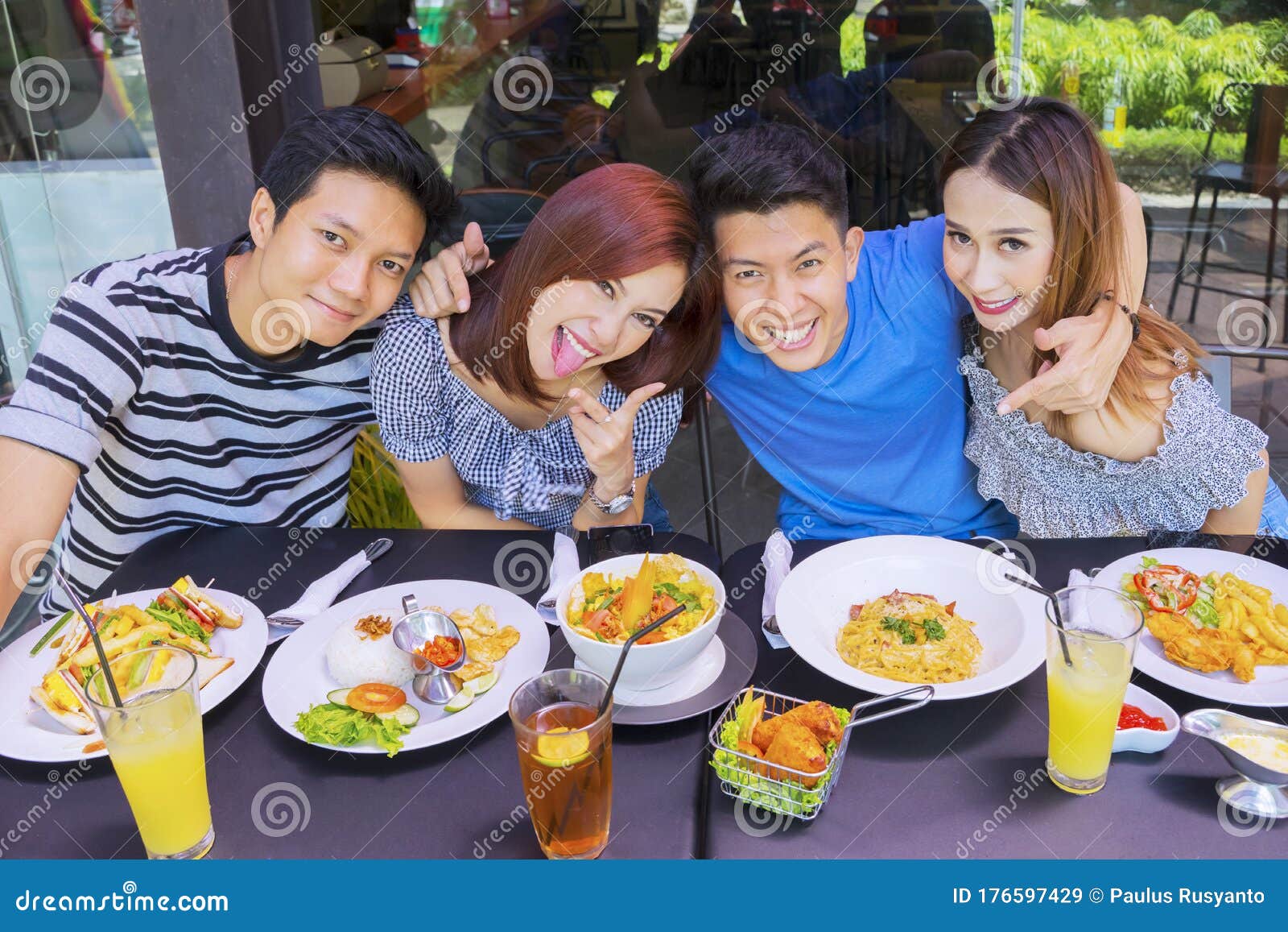 Happy Young People Smiling at Camera in Restaurant Stock Image - Image ...