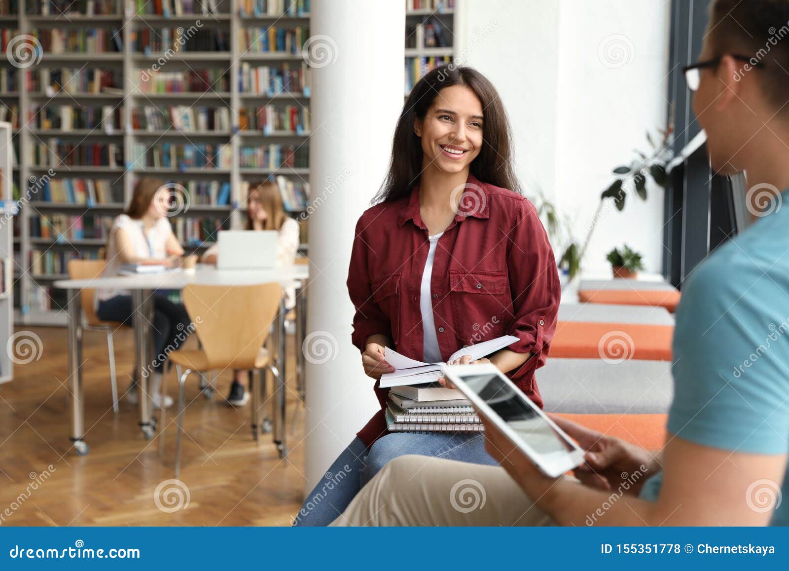 Happy Young People Talking in Library Stock Photo - Image of male ...