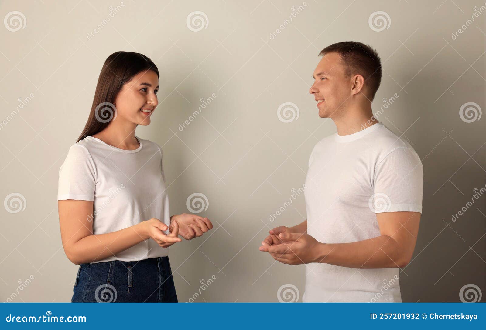 Happy Young People Talking on Light Background Stock Photo - Image of ...