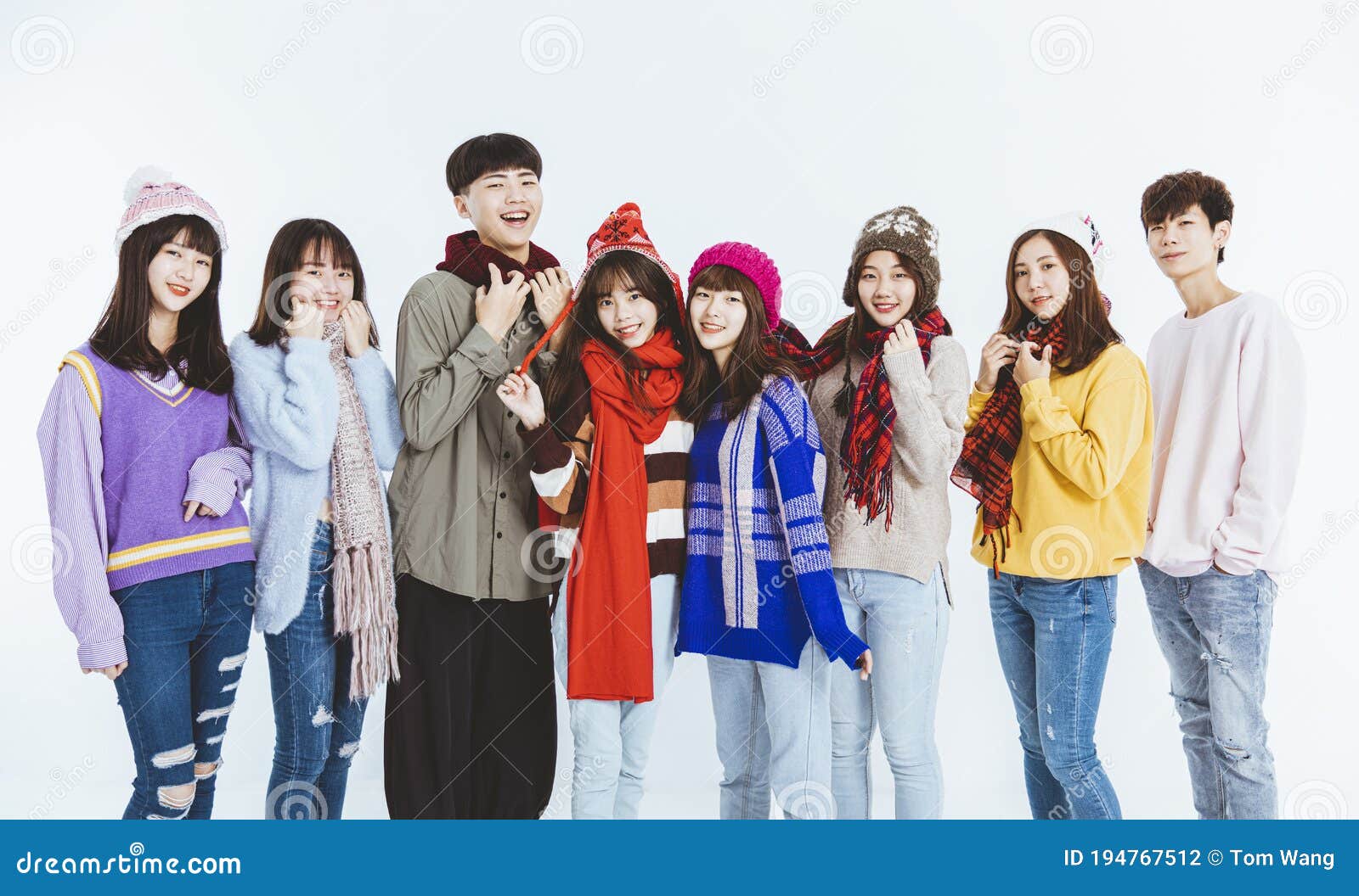 Happy Young People in Winter Clothes Standing Together Stock Photo ...